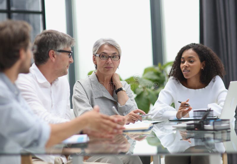 Conversation between Managers and Employees in the Office at the Table ...