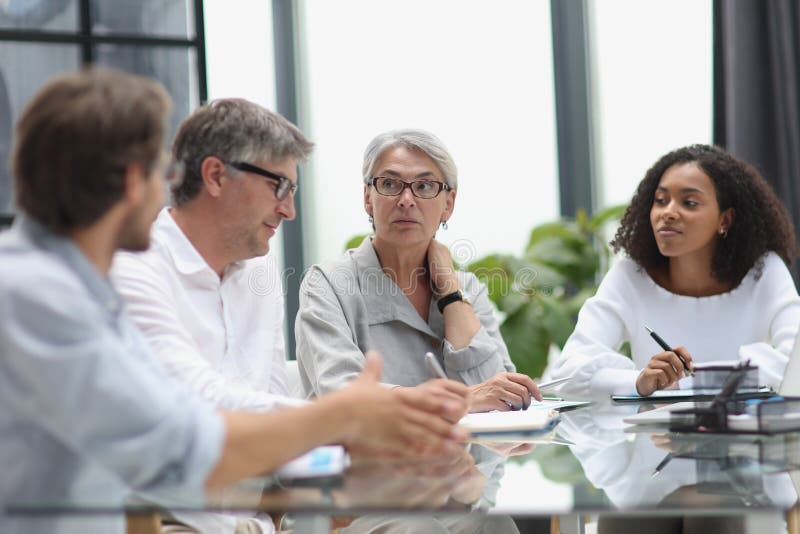 Conversation between Managers and Employees in the Office at the Table ...
