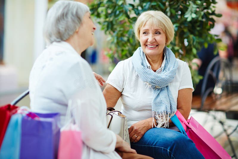Conversation of Mature Shoppers Stock Image - Image of paperbag, woman ...