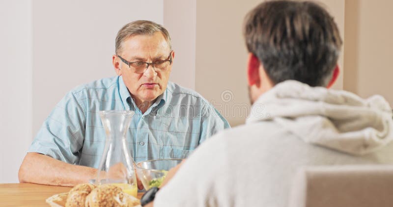 Conversation between Two Men of Different Ages at a Table, Having ...