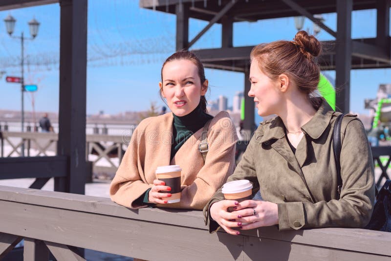 Conversation on a Walk Two Girls with Coffee in Hand Stock Image ...