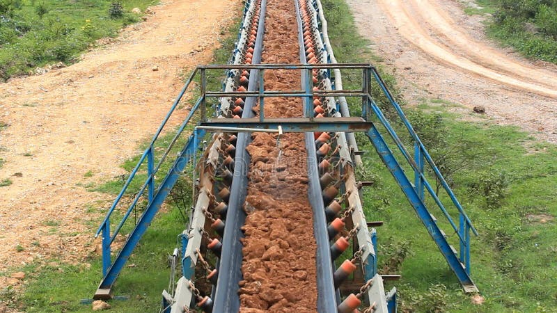 Conveyor Belt Transports Pots with Soil and Seeds while Worker Oversees ...