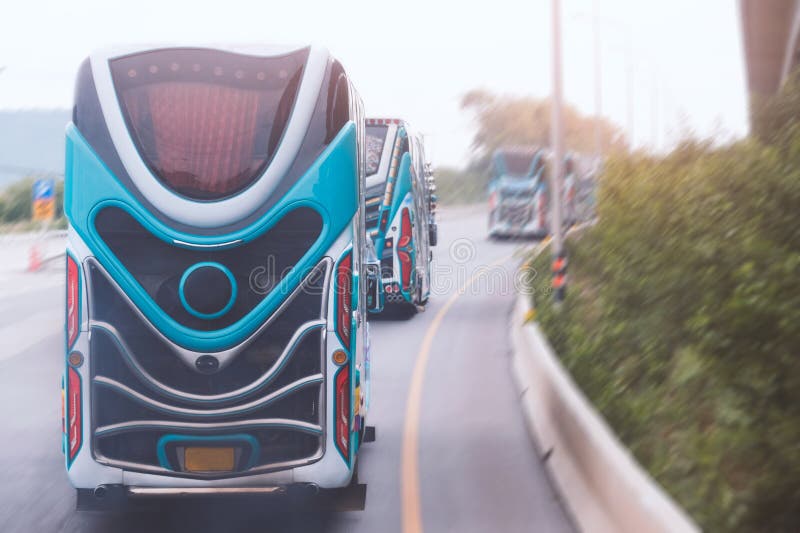 A Convoy of Buses Carrying Tourists is Running on the Highway in Rows ...