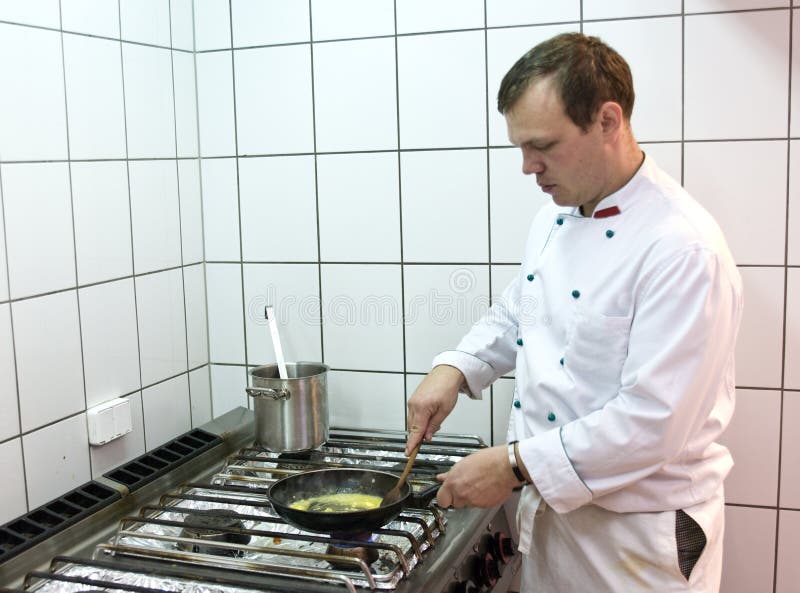 Cook in industrial kitchen stock photo. Image of interior - 34864862