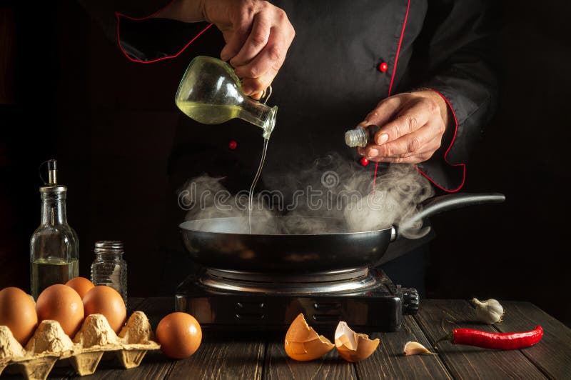 The Cook Adds Vegetable Oil while Cooking Eggs in Pan. Work Environment ...