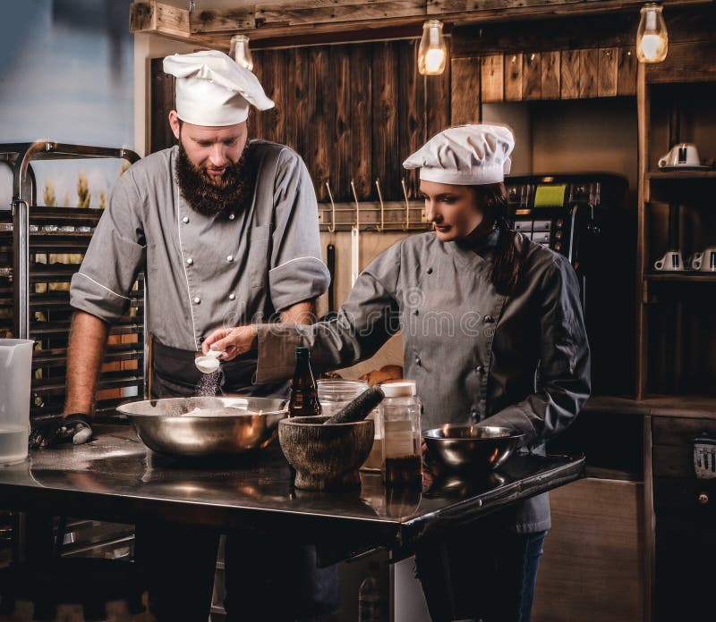 Assistant Cook Grinds Sesame Seeds in a Mortar for Cooking Bread. Chef ...