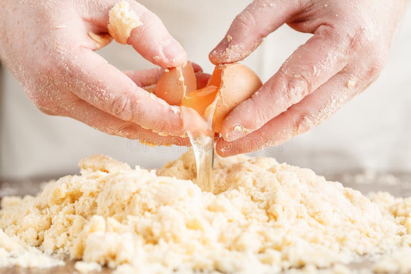 Cook breaking an egg stock photo. Image of caucasian - 78573450