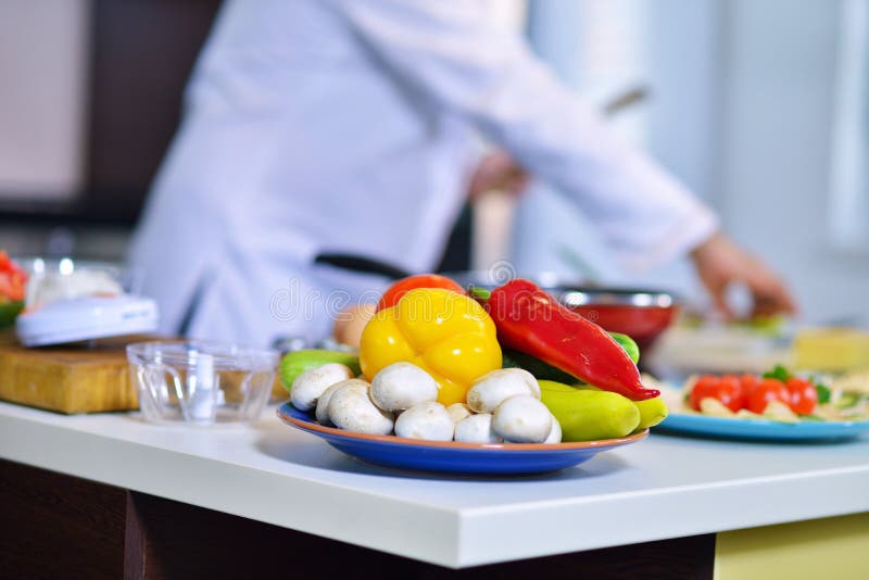 Cook Chef in Kitchen and Fresh Vegetables on Table Stock Image - Image ...