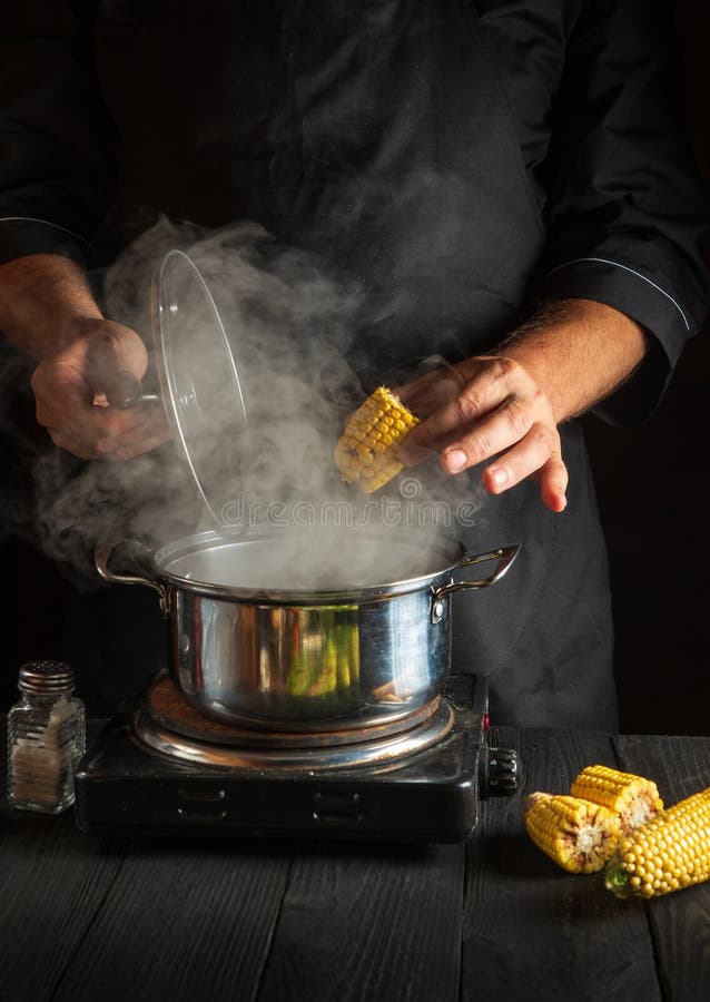 Cook Cooks Corn. Close-up of a Chef is a Hand while Cooking in ...