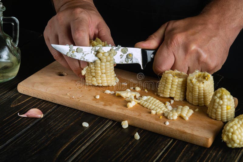 The Cook Cuts Boiled Corn Kernels with a Knife. Maize is an Excellent ...