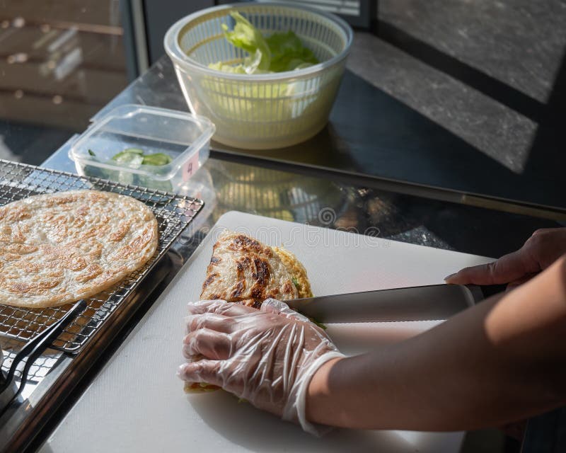 The Cook Cuts the Flatbread with Salmon. Quesadilla. Stock Image ...