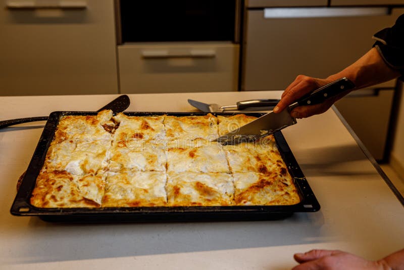 Cook Cuts Fresh Lasagna - Side View Stock Photo - Image of cheese ...
