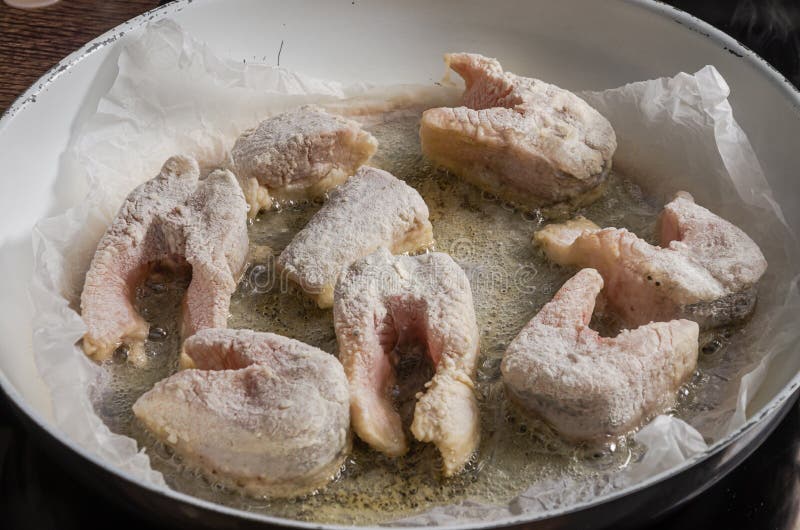 The Cook Cuts and Fries Pike Fish in a Frying Pan Stock Image - Image ...