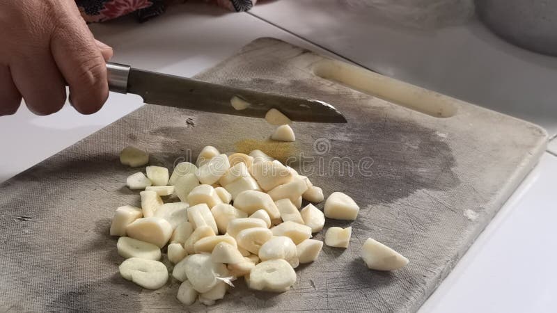 The Cook Cutting and Dice Garlic on a Cutting Board Stock Image - Image of individuality, favor ...