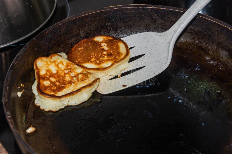 The Cook is Frying Pancakes in a Frying Pan Stock Image - Image of ...