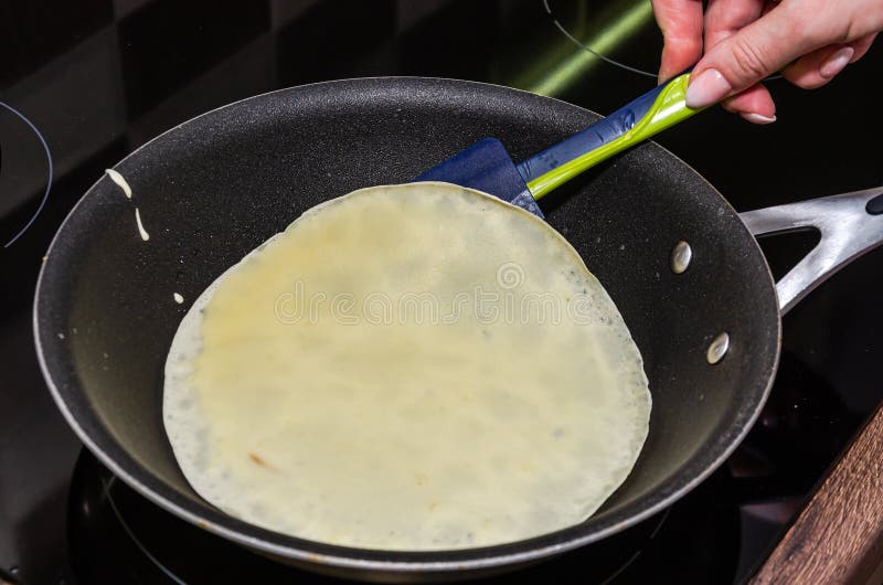The Cook is Frying Pancakes in a Frying Pan Stock Photo - Image of ...