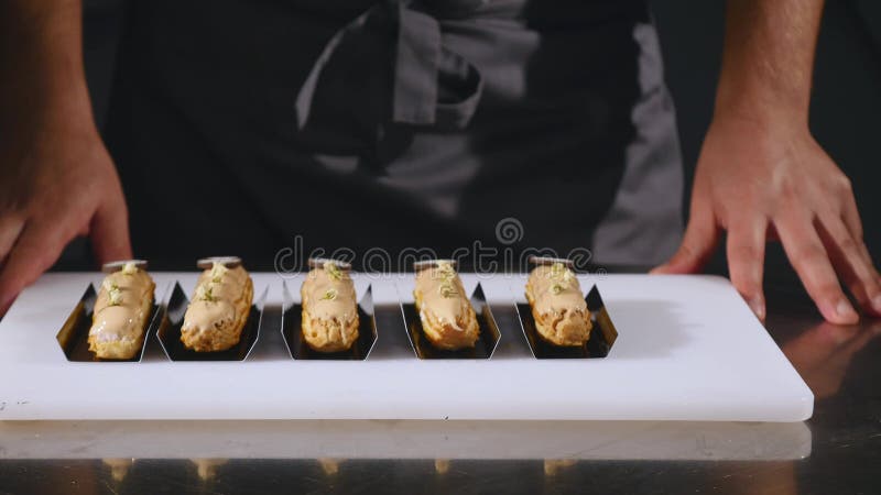 Cook Gently Decorated with Freshly Baked Eclairs Using Meringue ...