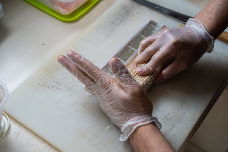 Cook Hands Making Japanese Sushi Roll. Japanese Chef at Work Preparing ...