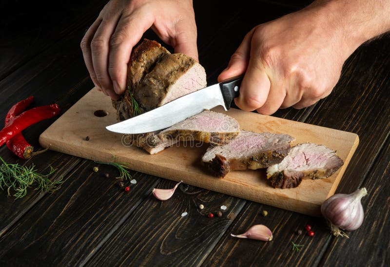 Cook Hands are Slicing Grilled Beef Meat on Cutting Board. Work ...