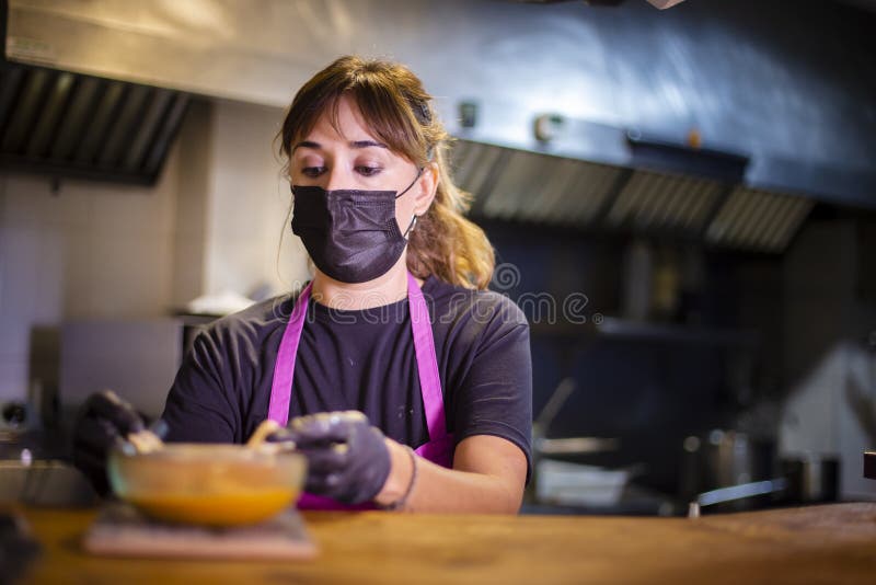 Cook in the Kitchen of a Restaurant Taking a Dish with the Safety ...