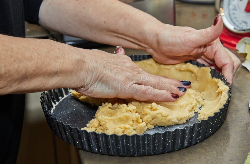 Cook Kneads the Dough in a Mold for Making a Pie in the Kitchen Stock ...