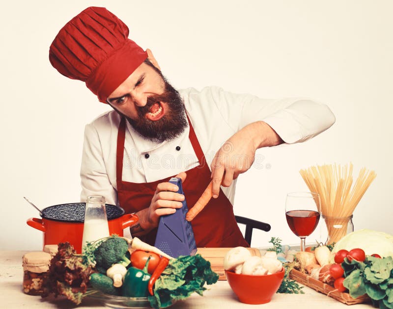 Cook with Mad Face Sits by Kitchen Table with Vegetables Stock Image ...