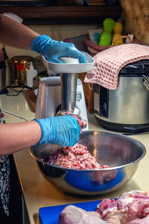 Cook Makes Minced Fresh Meat in a Meat Grinder. the Process of Grinding ...