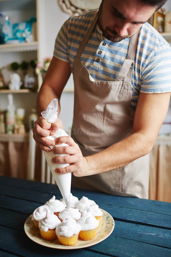 Cook making cupcakes stock image. Image of decorating - 68735211