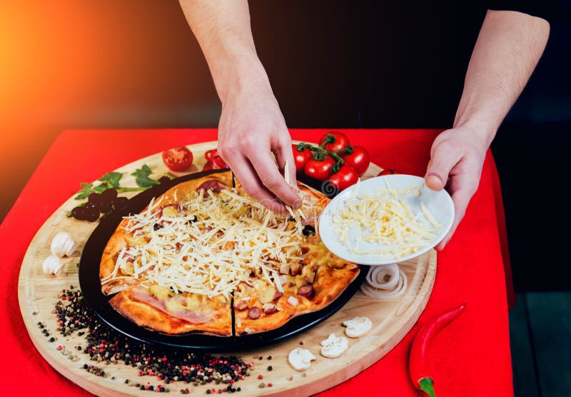 The Cook is Making Pizza. Adds the Ingredients Stock Photo - Image of ...