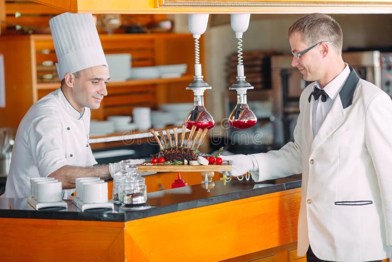 The Cook Passes the Waiter the Finished Dish. Rack of Lamb. Stock Photo ...