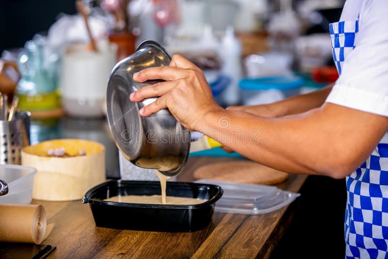 The Cook Pours the Batter Out of the Bowl into a Baking Dish. Master ...