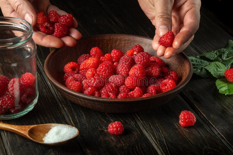 The Cook Prepares Compote or Fruit Drink with Raspberries. Chef Hands ...
