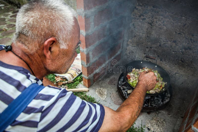 The Cook Prepares Food in Nature Stock Photo - Image of cook, flame ...