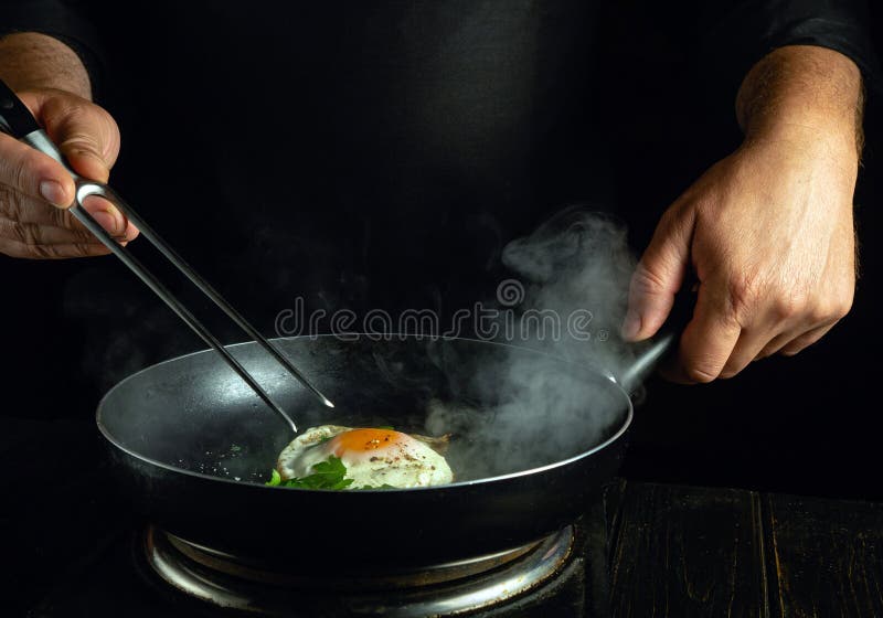 The Cook Prepares Fried Eggs for Breakfast. Delicious Food with Eggs ...