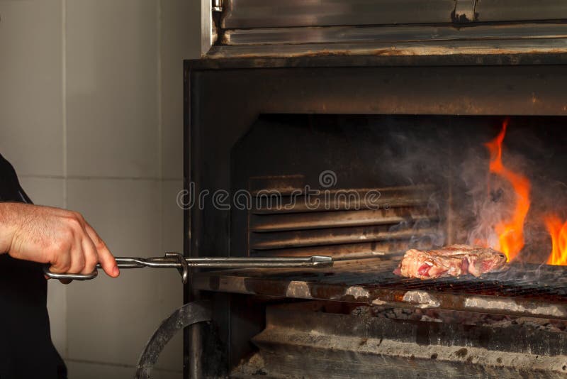 A Cook Prepares Meat on a Fire in a Stove Stock Image - Image of ...