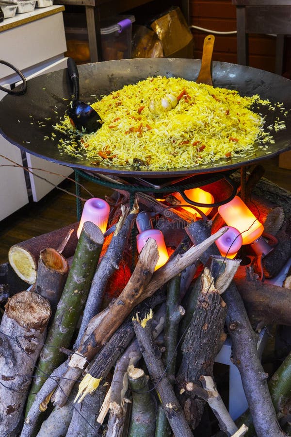 Cook Prepares Pilaf, a Dish of Rice and Meat on a Campfire in the ...