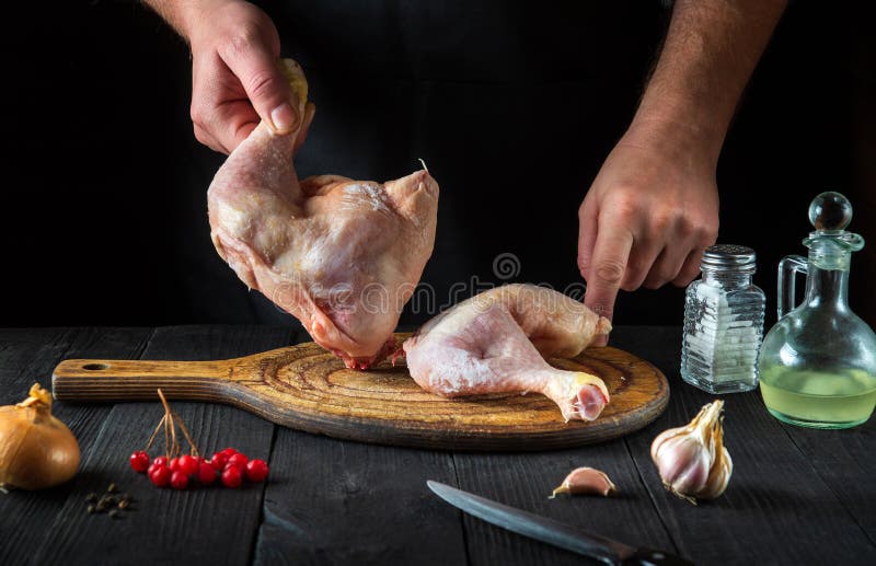 The Cook Prepares Raw Chicken Legs in the Restaurant Kitchen. Chicken ...