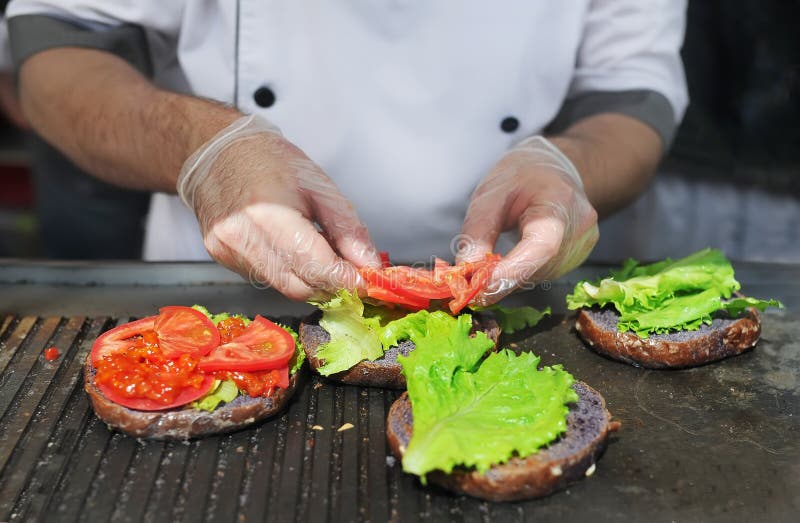 The Cook Preparing Burger Adding the Tomato. Ingredients for ...