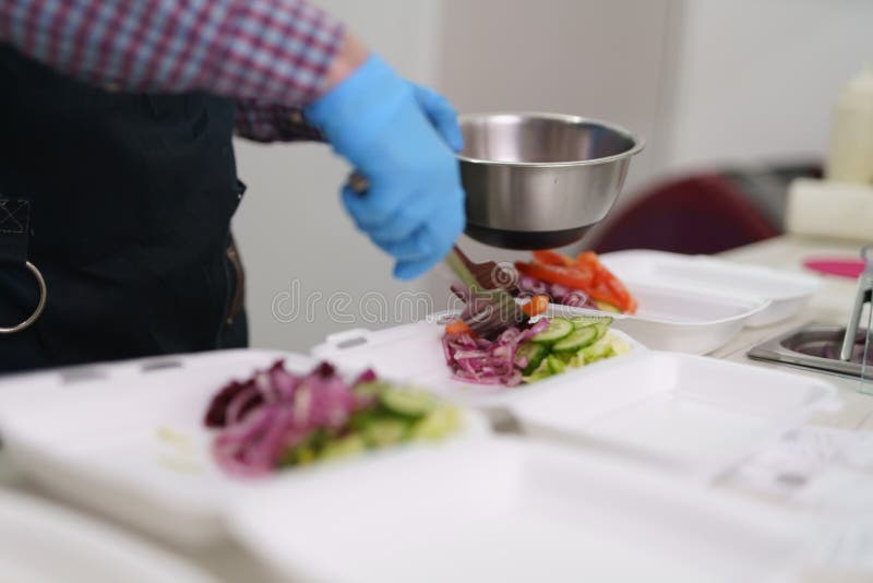 Cook Preparing Lunch Boxes with Sliced Vegetables on a Kitchen Counter ...