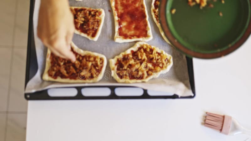 Chef Adding Fried Onions on Small Puff Pastries with Tomato Sauce Stock ...