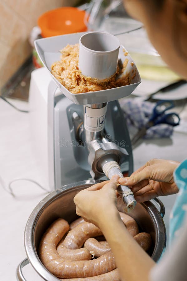 Cook Pulls the Gut on the Electric Meat Grinder for Preparing Sausage ...