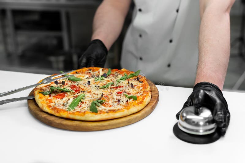 Cook with a Ready-made Dish with Pizza Stock Photo - Image of bell ...