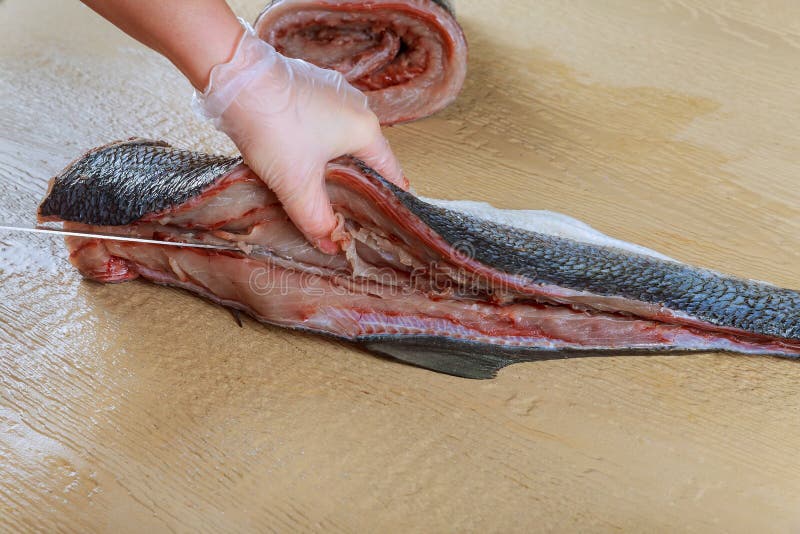 Cook Separates Fish Fillet from the Bone on a Cutting Board Stock Image ...