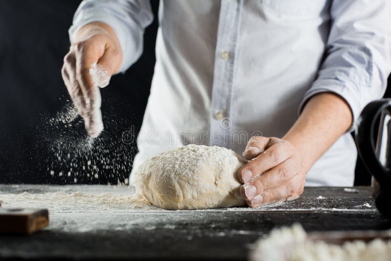 Cook Sprinkles Dough with Flour on the Kitchen Table Stock Image ...