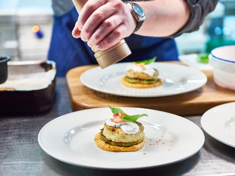 Cook Sprinkles Seasoning in Dish with Fish Cutlet in Restaurant Stock ...