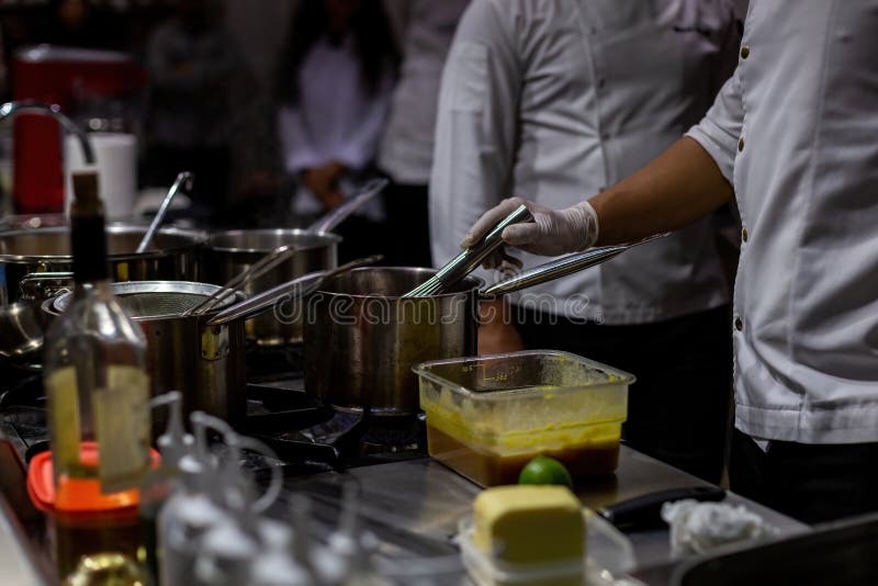 A Cook Stirring Pots in the Kitchen. Big Pots in the Kitchen Stock ...