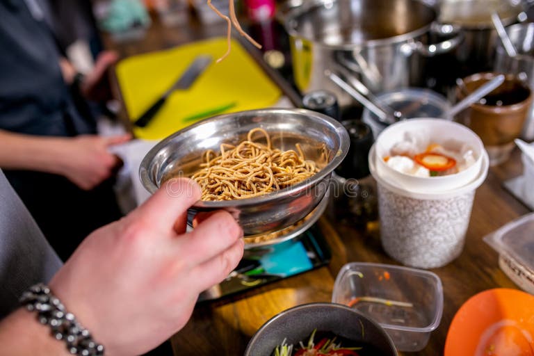 Cook Takes Boiled Noodles in a Colander. Master Class in the Kitchen ...