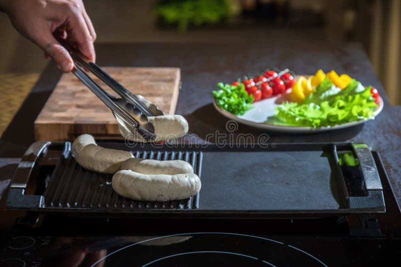 A Cook Turns Over Tongs of Chicken To a Grilled Stock Image - Image of ...