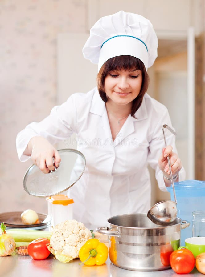 Cook Woman in Toque Cooks in Kitchen Stock Photo - Image of kitchen ...