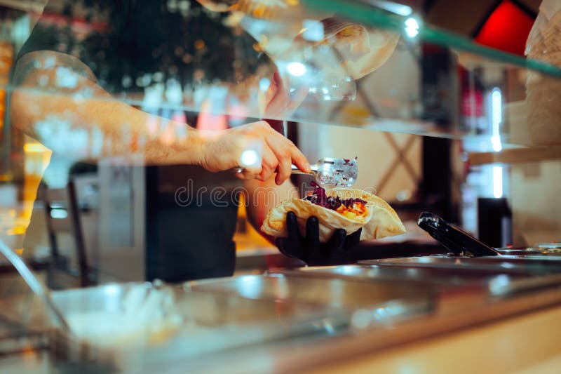 Fast Food Worker Assembling a Flat Bread Sandwich in a Restaurant Stock ...